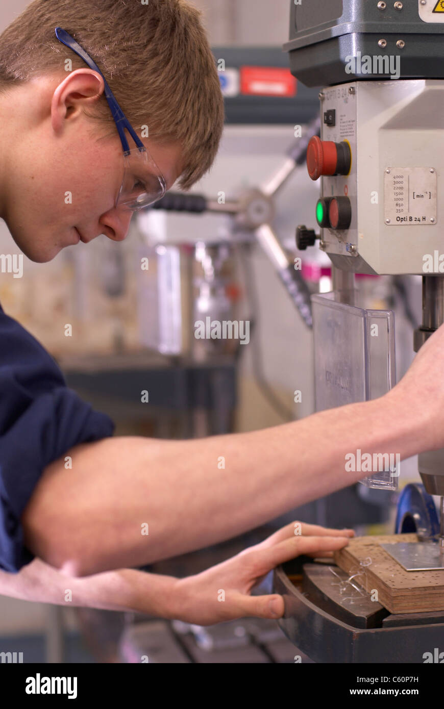 Worker using saw in factory Stock Photo - Alamy