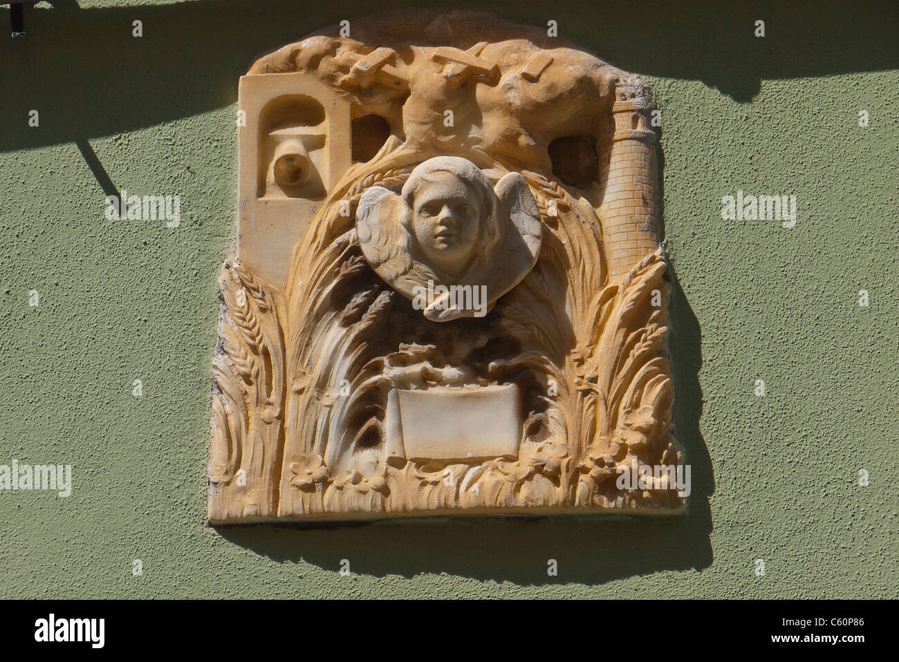Bas relief wall plaque that has cupid in center accompanied by a castle ...