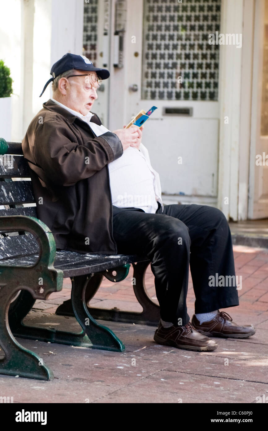 Brighton East Sussex South Lanes obese fat corpulent man male sitting ...