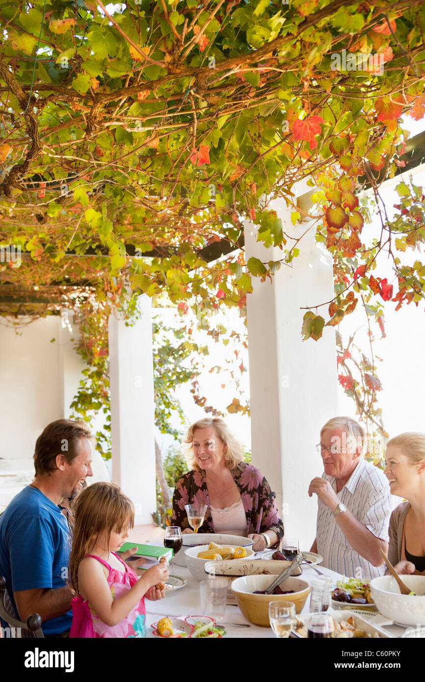 Family eating at table outdoors Stock Photo - Alamy