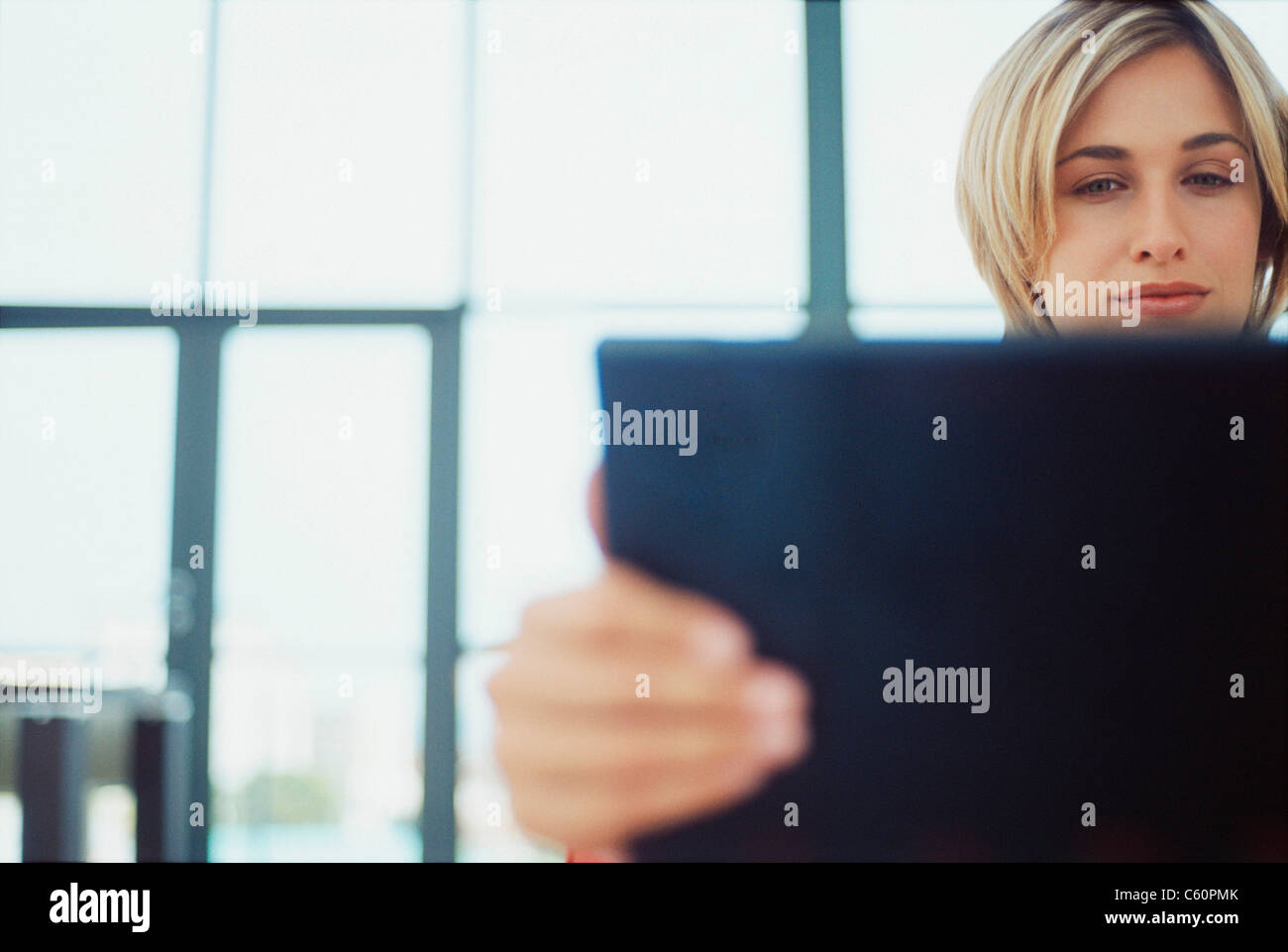 Woman opening laptop Stock Photo - Alamy