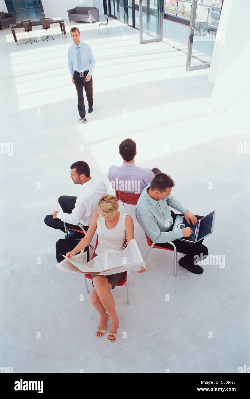 Business people working in lobby Stock Photo - Alamy