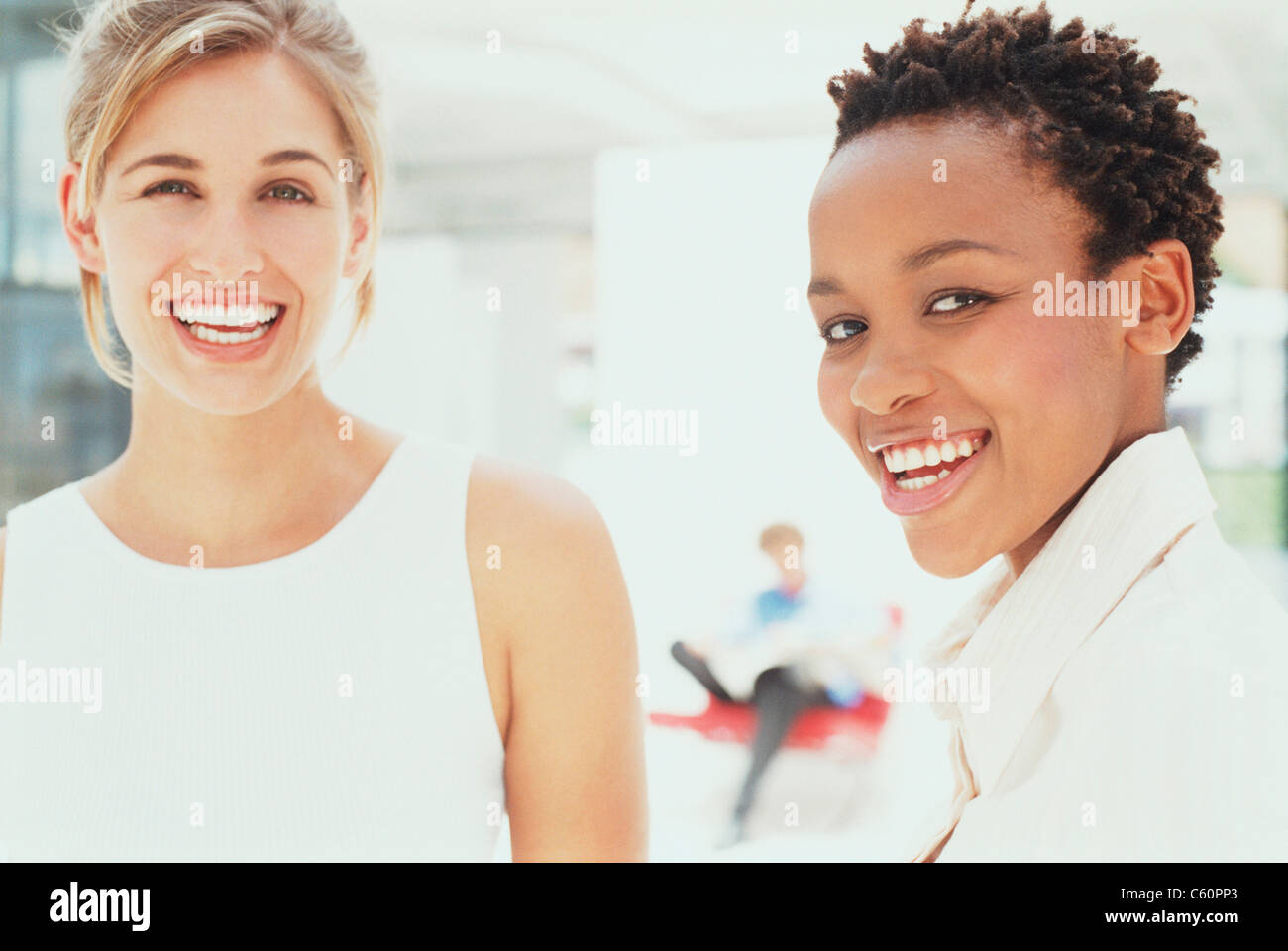 Businesswomen smiling together Stock Photo - Alamy