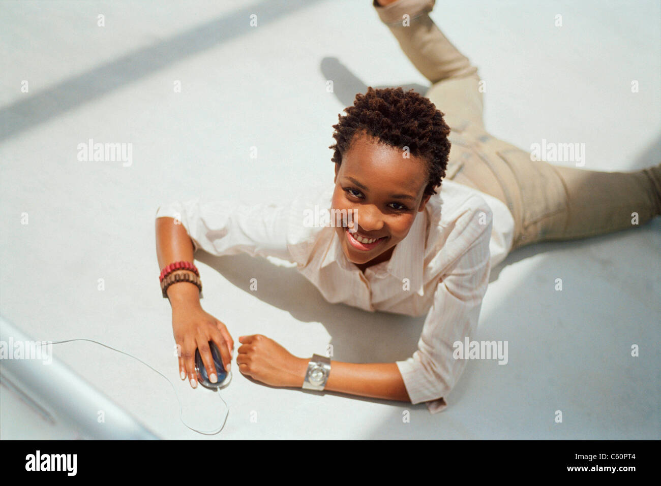 Businesswoman using computer on floor Stock Photo - Alamy