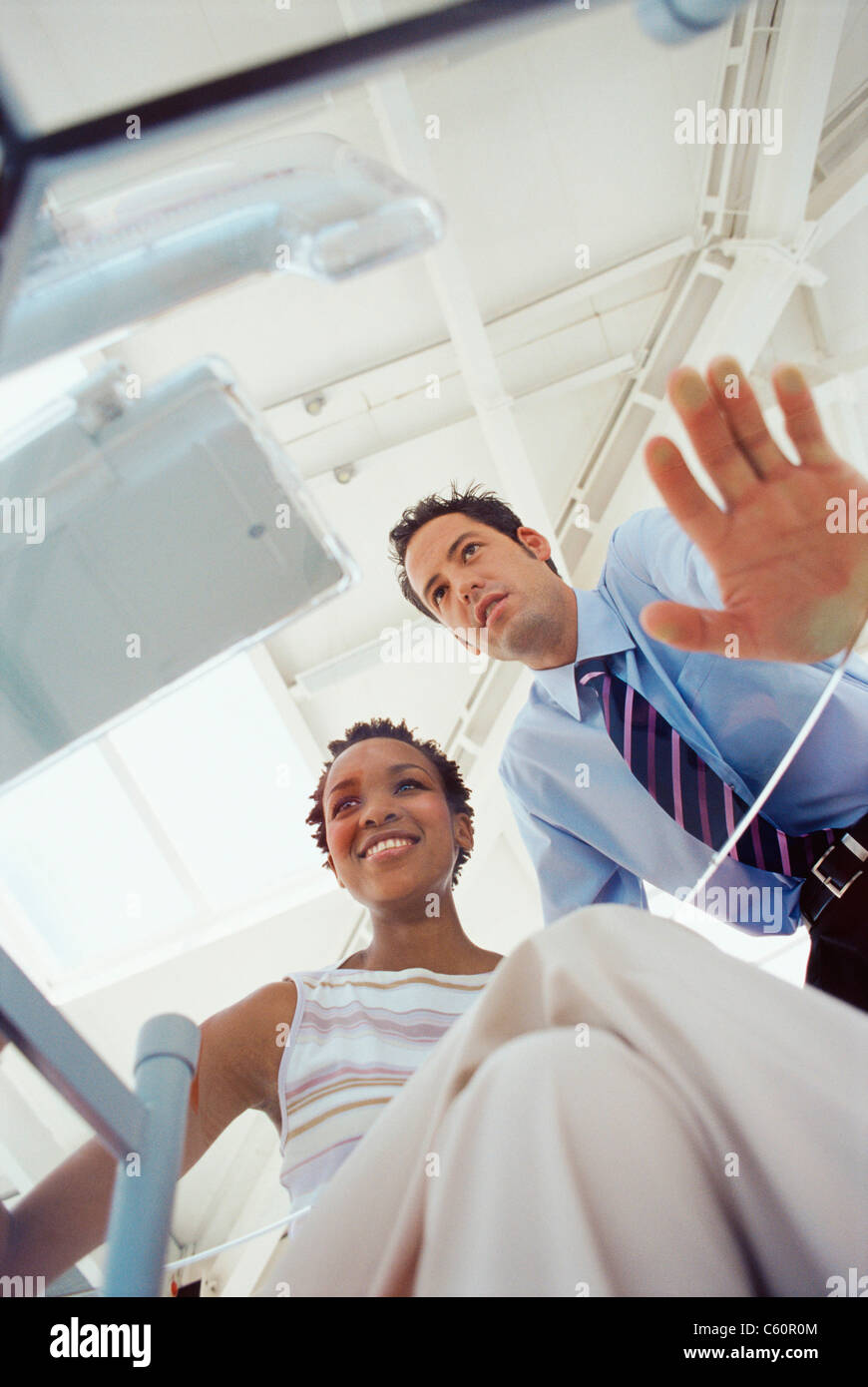 Two business people reviewing computer hi-res stock photography and ...