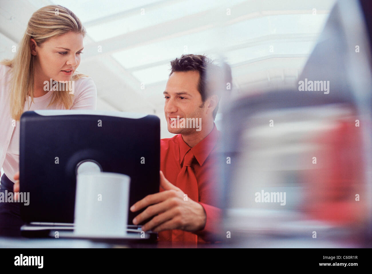 Business people using laptop together Stock Photo - Alamy