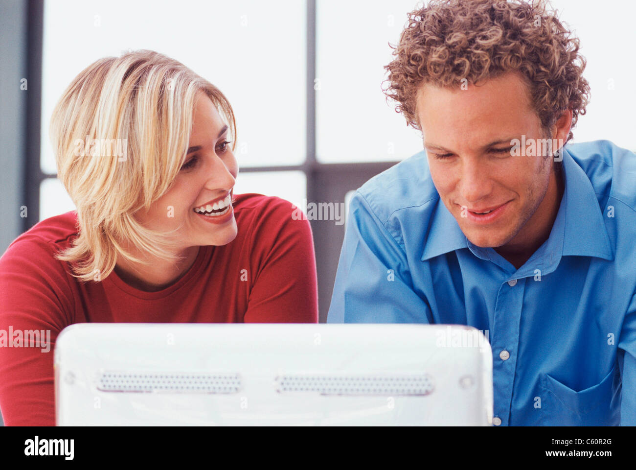 Business people using computer together Stock Photo - Alamy