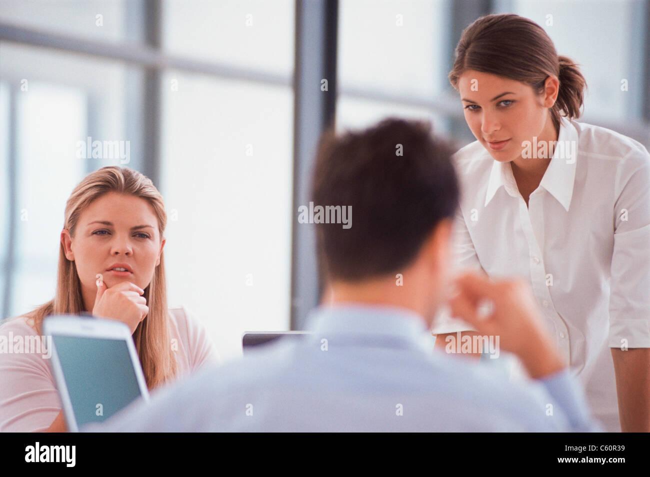 Business people talking at desk Stock Photo - Alamy