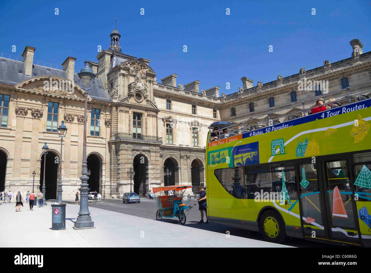 Yellow tourist bus outside the Louvre complex, Paris France Stock Photo ...
