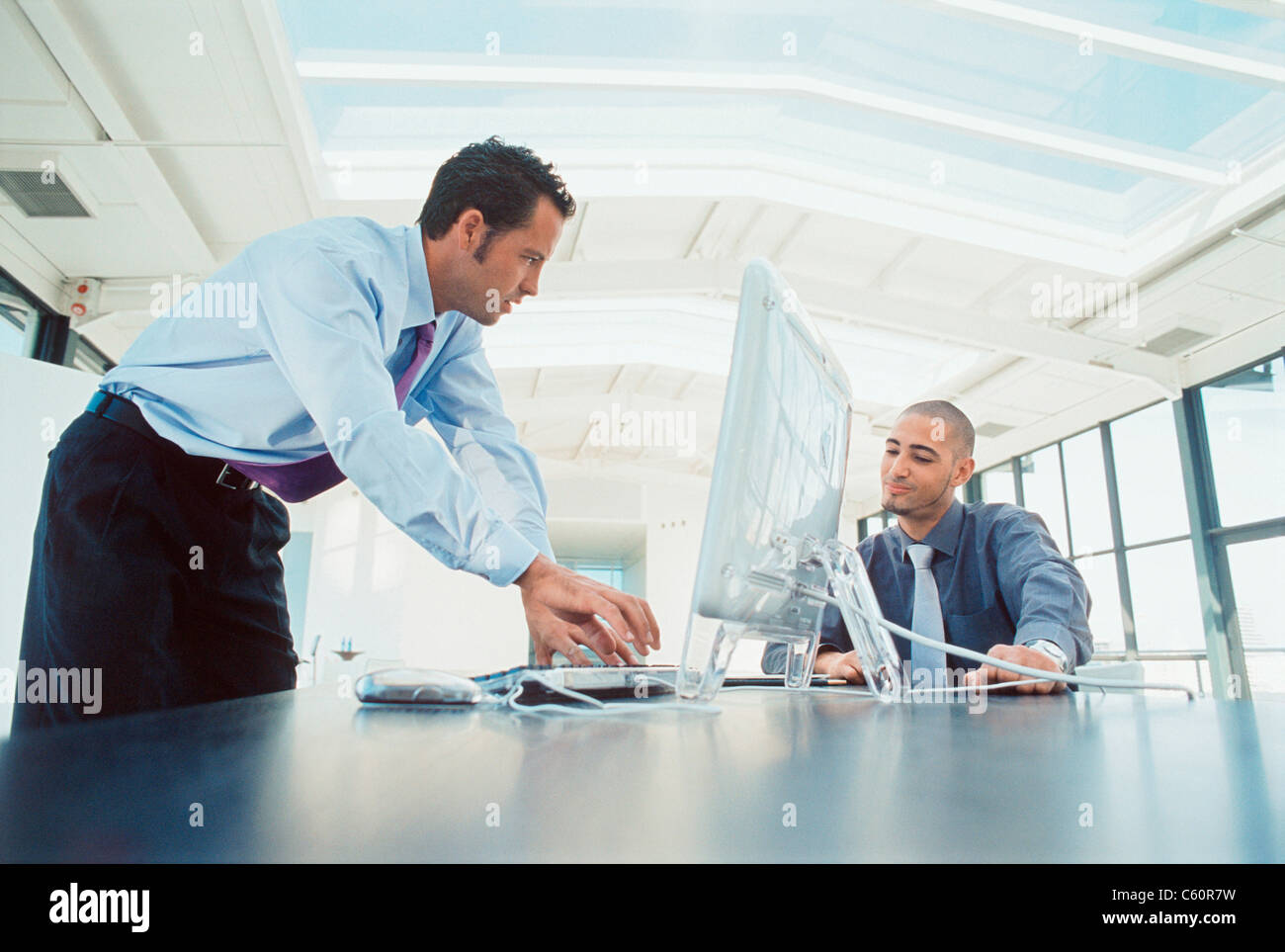 Businessmen working on computer Stock Photo - Alamy