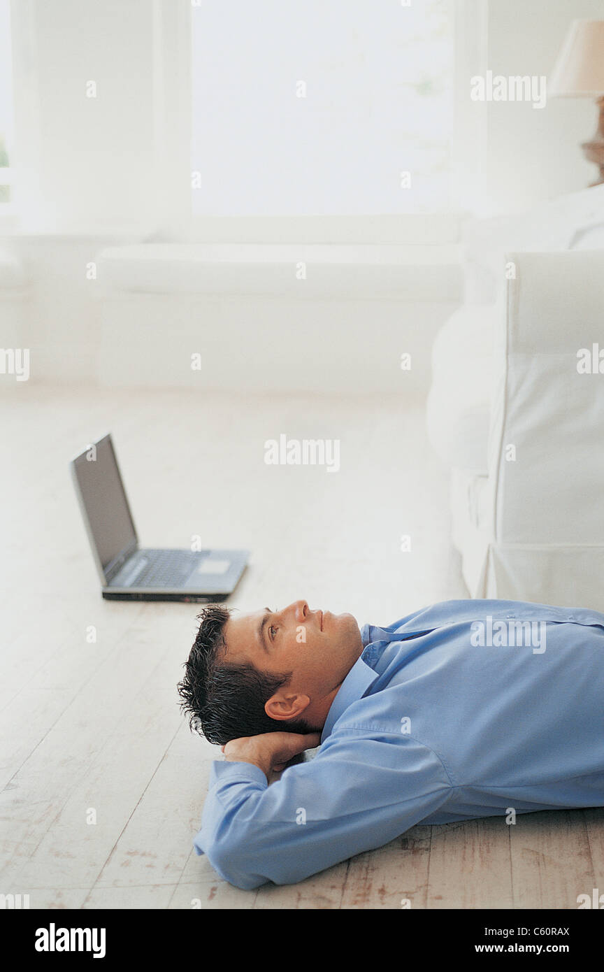 Businessman laying on floor Stock Photo - Alamy