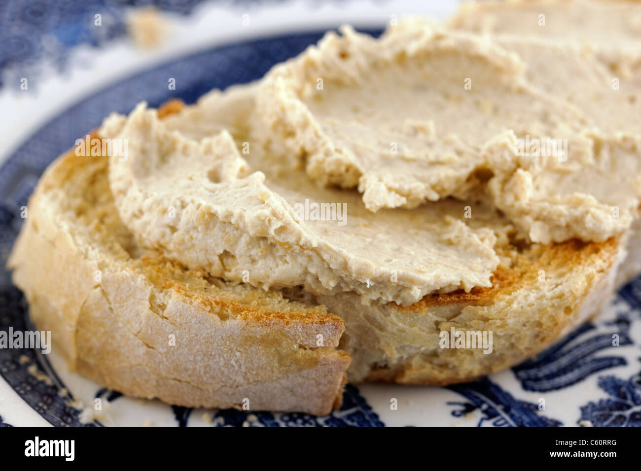 Thickly homemade Hummus with extra garlick spread on freshly toasted ...