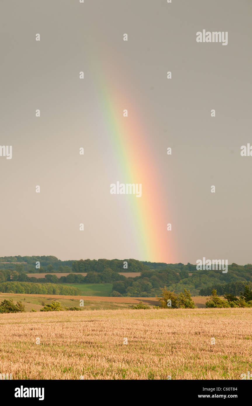 Rainbow over field Stock Photo - Alamy