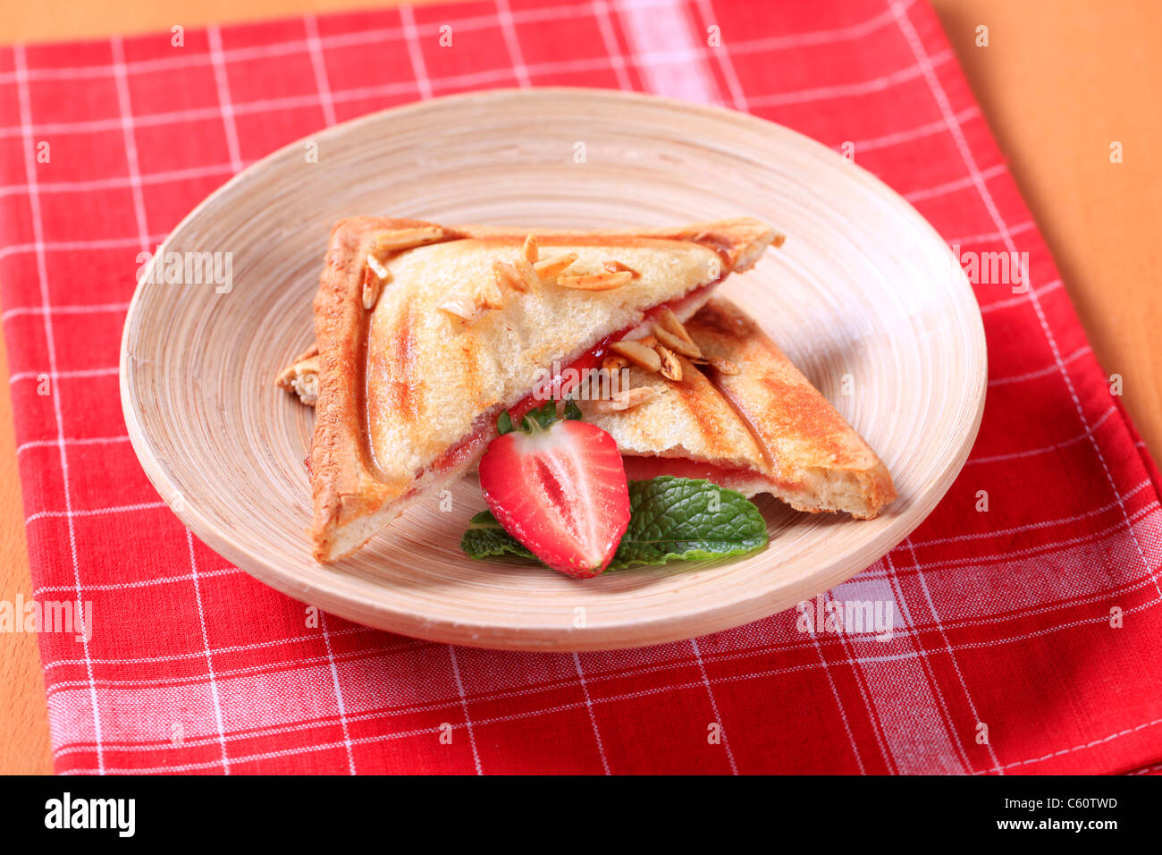 Toasted sandwich filled with strawberry jam - closeup Stock Photo - Alamy