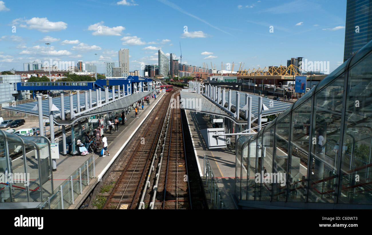 A view looking east of empty rail tracks with passengers waiting for ...