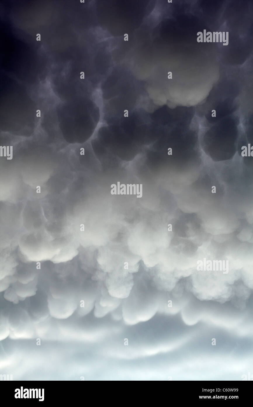 Spectacular closeup of mammatus cloud formation with glow of lightning ...