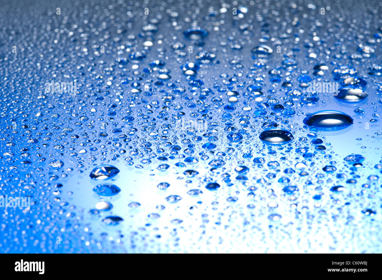 Water drops on a shiny surface in blue Stock Photo - Alamy