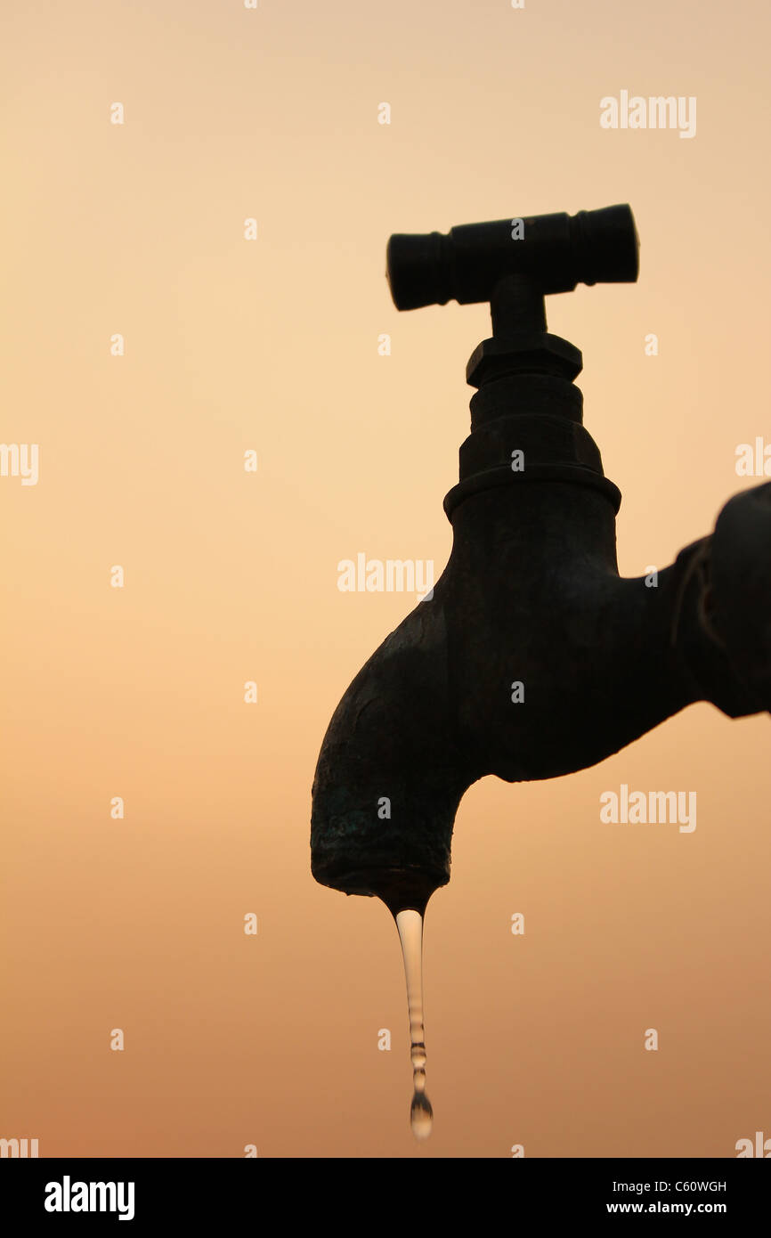 falling drop from tap in the evening Stock Photo - Alamy