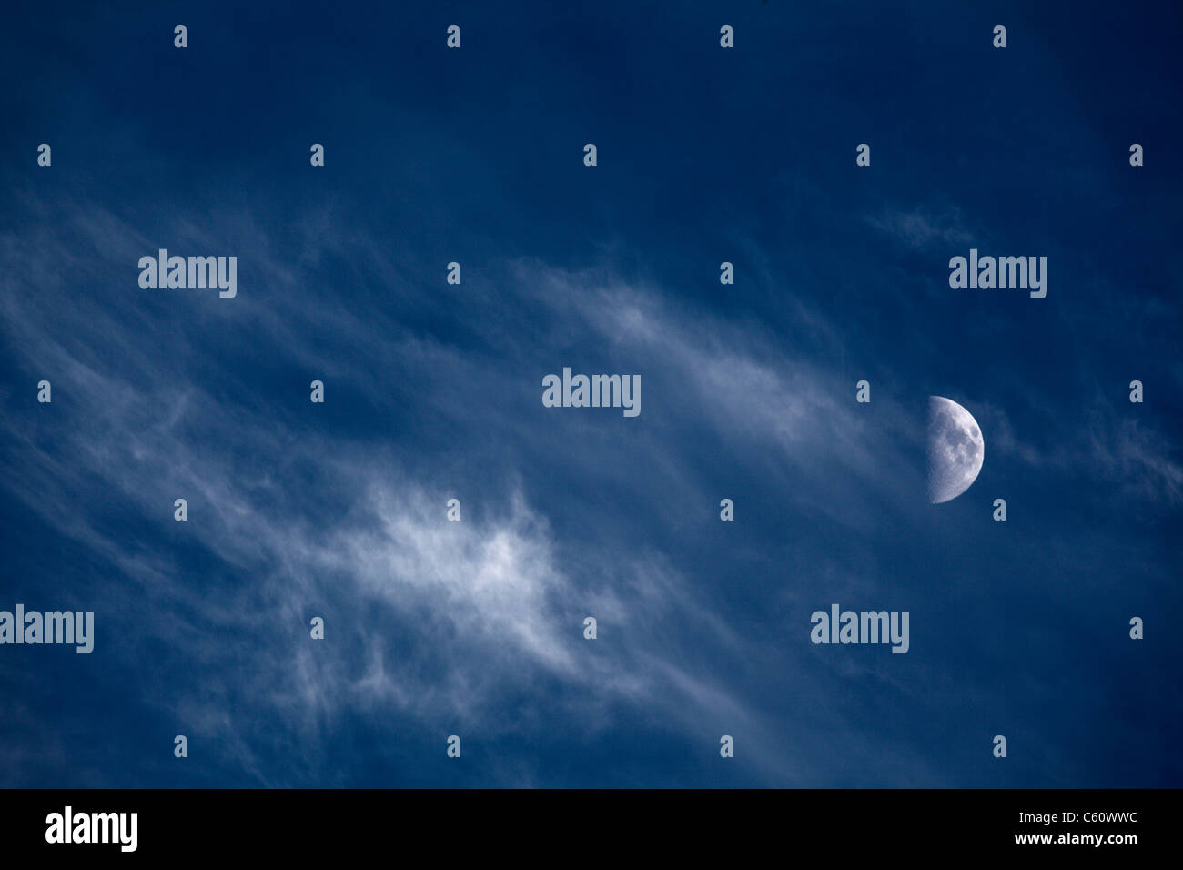 Moon and cirrus clouds on a deep blue sky Stock Photo - Alamy