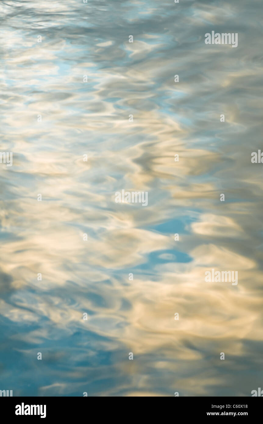 Blue sky reflections in a lake right before a thunder storm Stock Photo ...