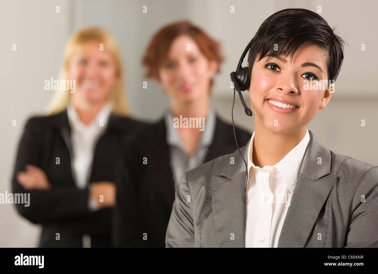 Pretty Hispanic Businesswoman with Colleagues Behind in an Office ...