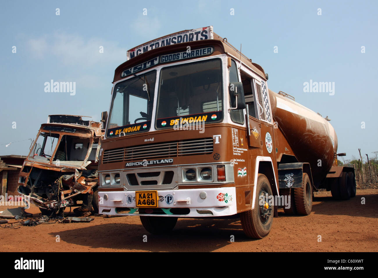Heavily loaded bulk carrier truck next to smashed vehicle in Karnataka ...