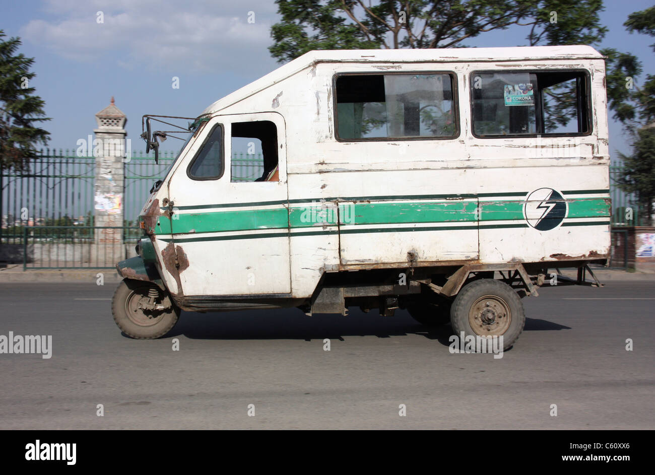 Three wheeler taxi bus races through city streets in Kathmandu Nepal ...