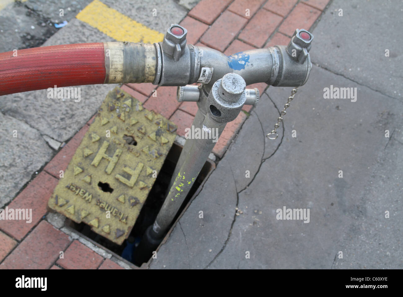 Fire brigade hose attached to water supply in Croydon, London, UK Stock ...