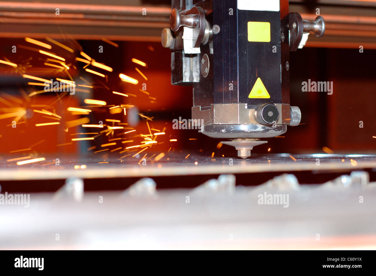 Industrial laser with sparks flying around Stock Photo - Alamy