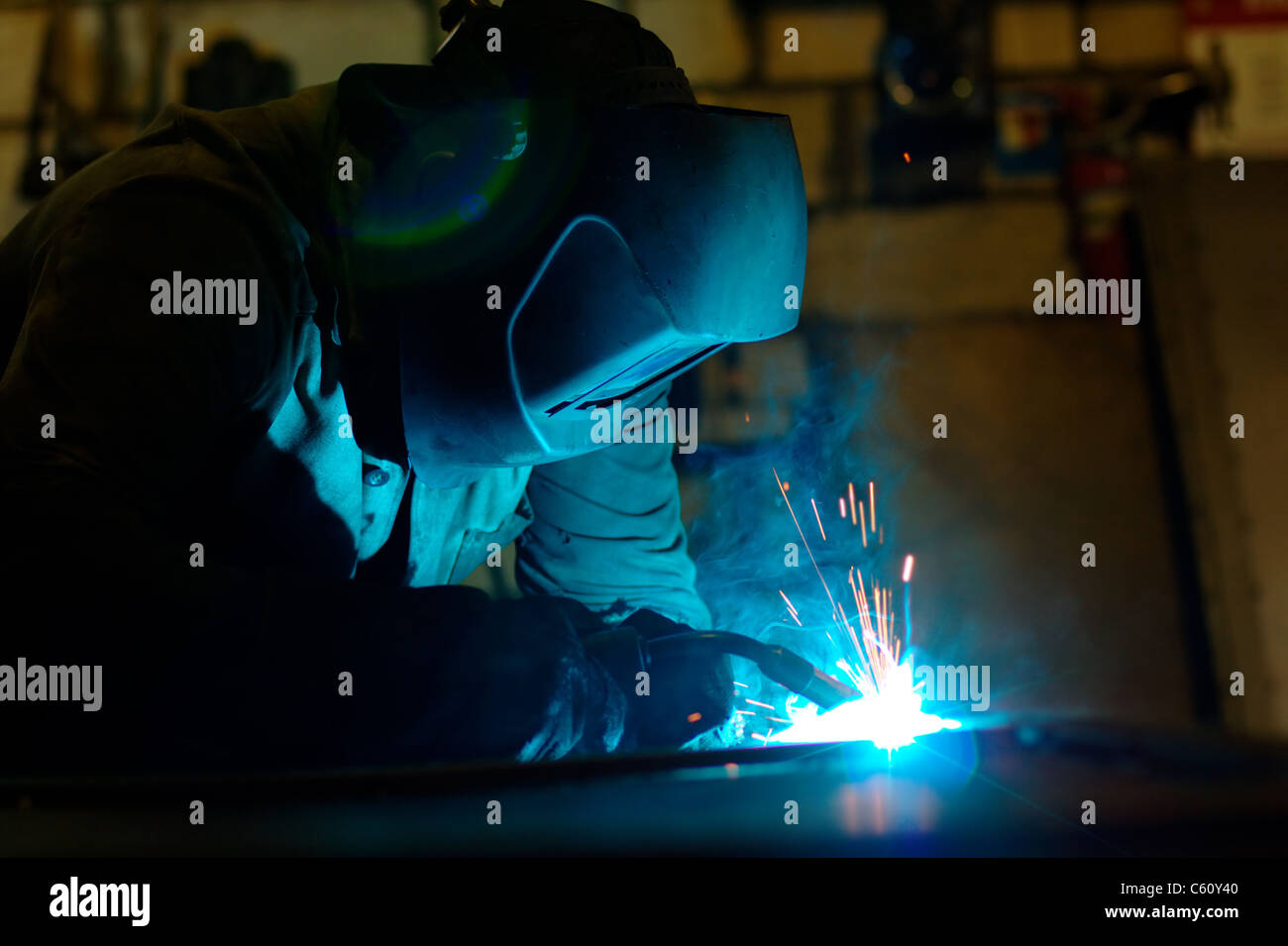 Portrait of a welding process with sparks flying around Stock Photo - Alamy