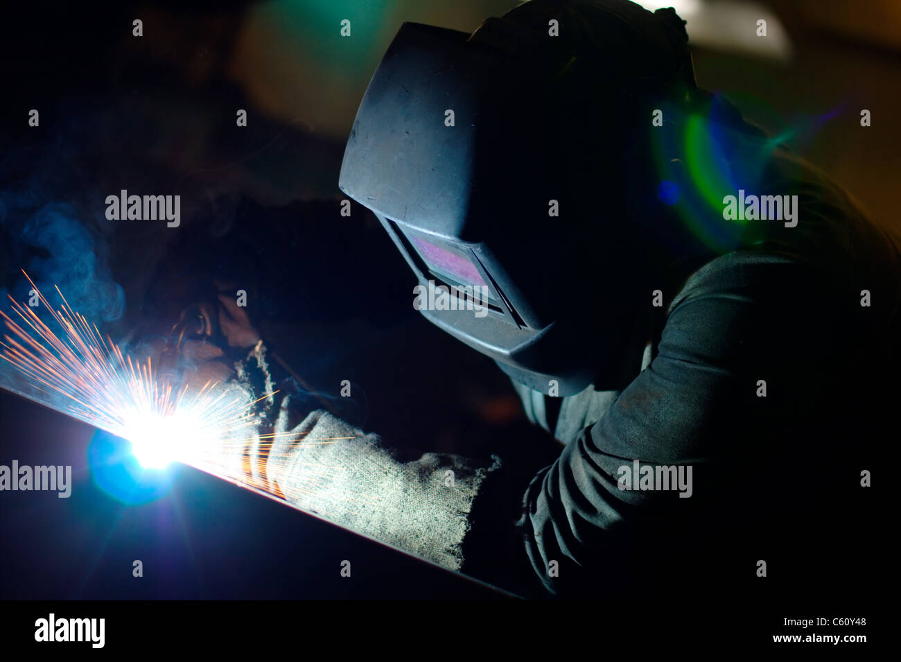 Portrait of a welding process with sparks flying around Stock Photo - Alamy