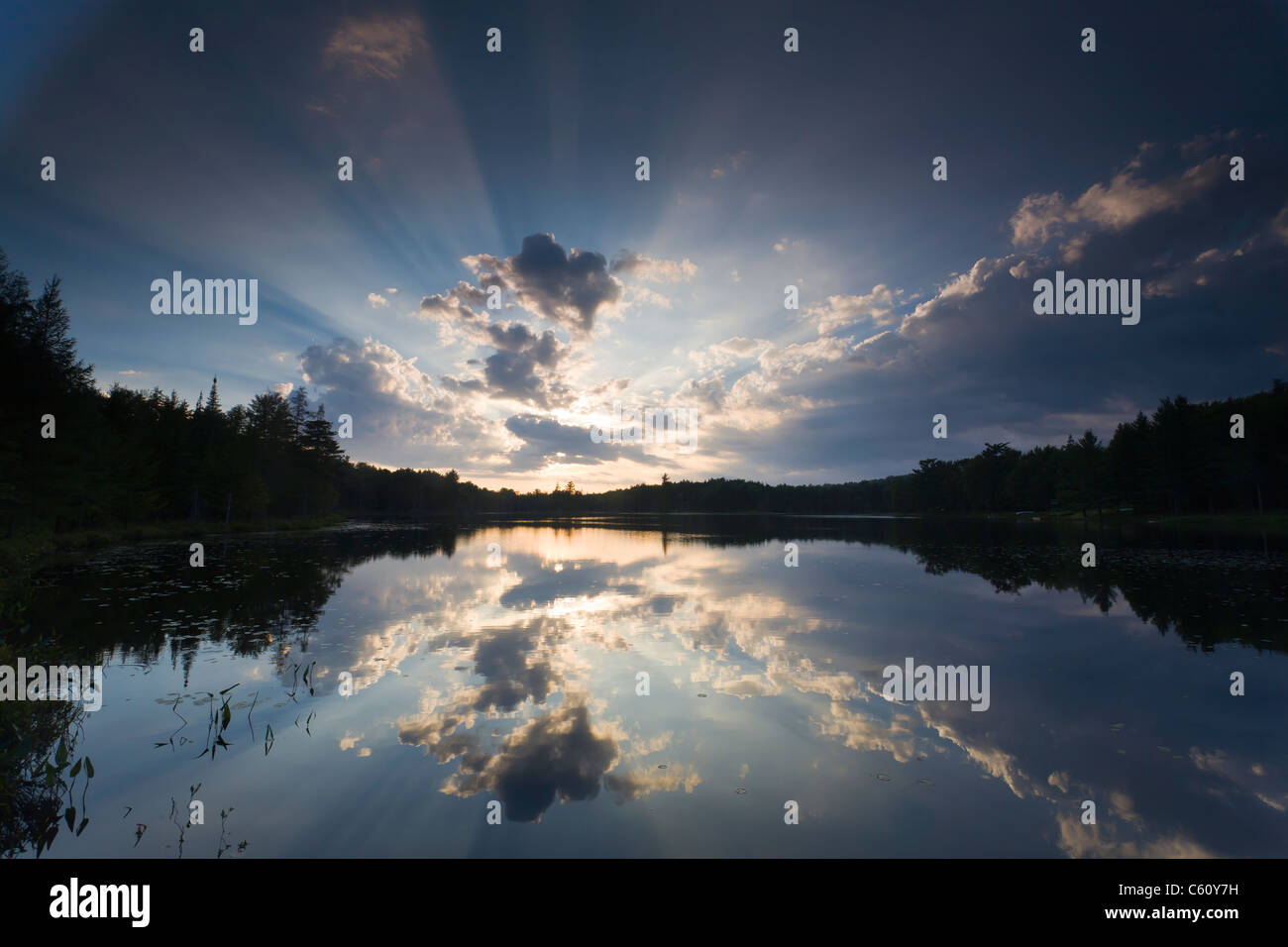 Sunset over Twin Pond in the Adirondack Mountains in Old Forge New York ...