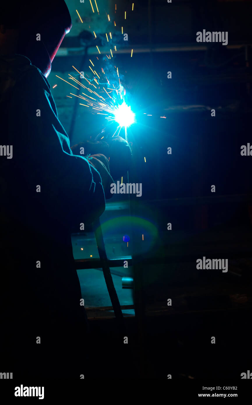 Photo of a welding process with sparks flying around Stock Photo - Alamy