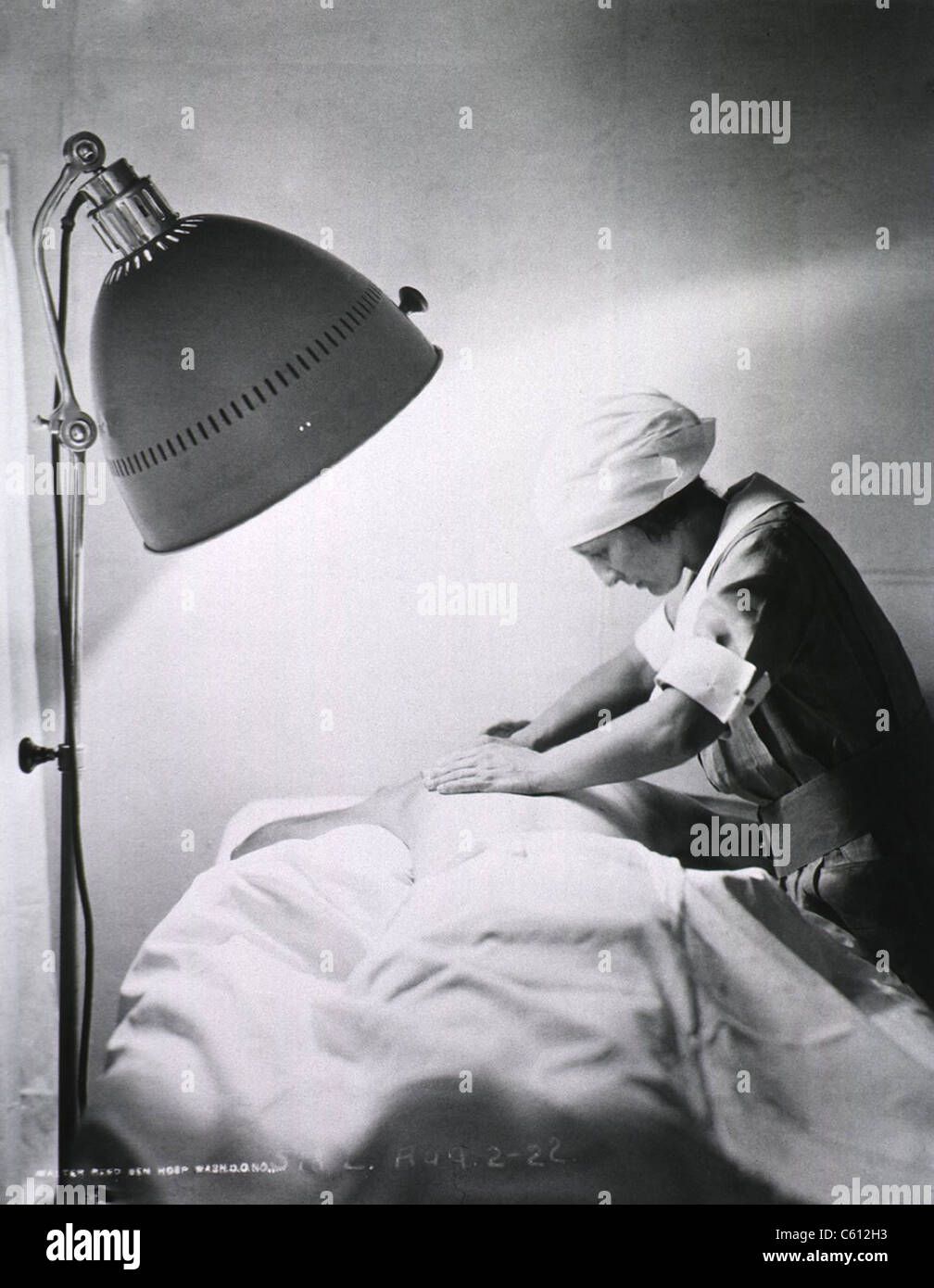 Nurse giving back rub to a patient in Walter Reed General Hospital ...