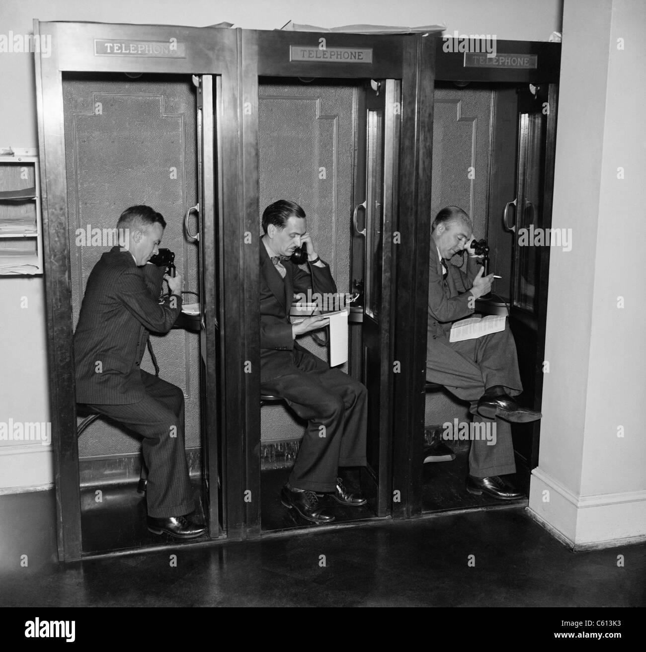 Reporters in telephone booths in White House press room, ca. 1937 Stock ...