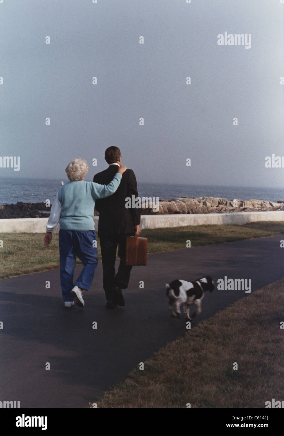 President George and Barbara Bush walk as Millie trots alongside Walker ...