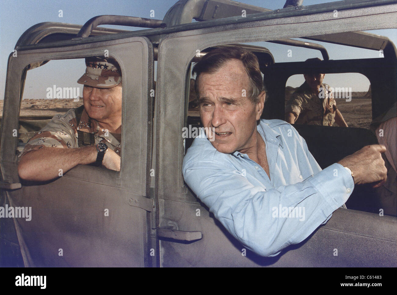 President George Bush riding in an armored jeep with General ...