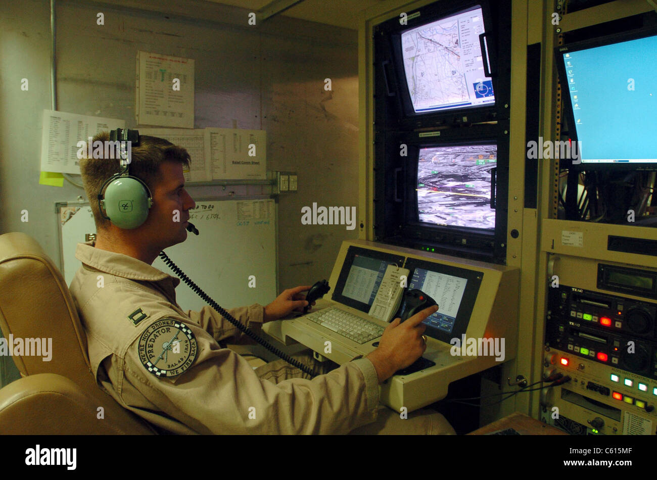 An Air Force officer maneuvers an unmanned Predator reconnaissance ...