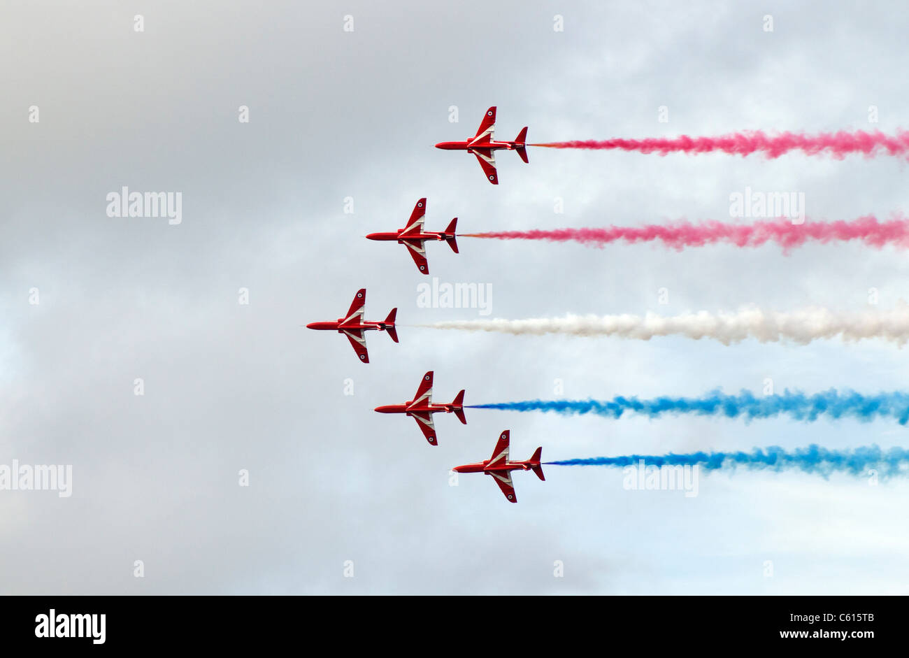 Five Red Arrows jets with red white and blue colour smoke trails in an ...