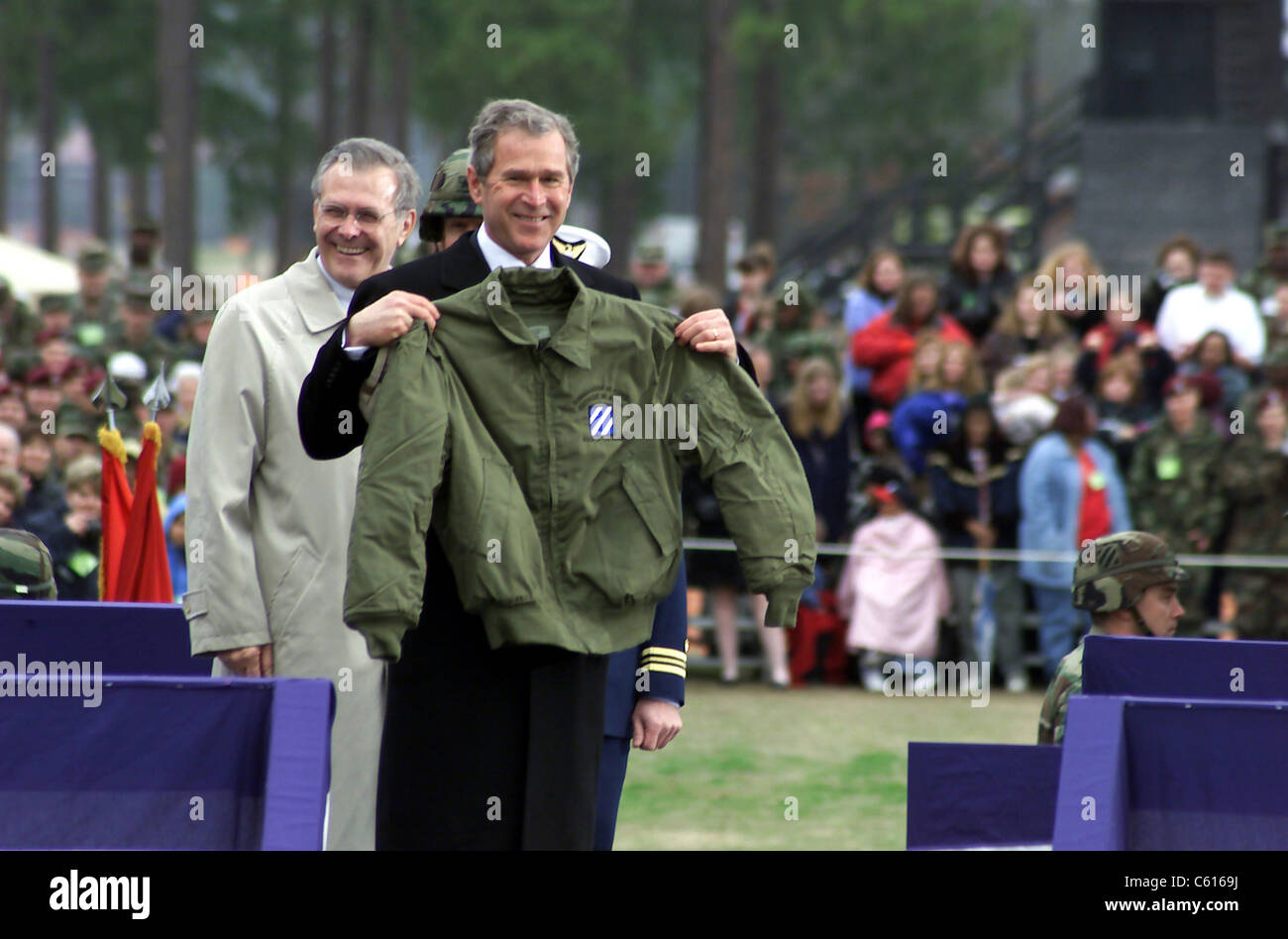 President Bush displays a jacket given to him when he visited soldiers ...