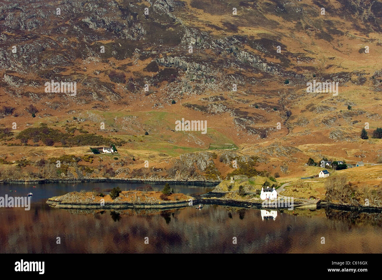 The jetty, house and ruined Strome Castle at Stromemore on Loch Carron ...