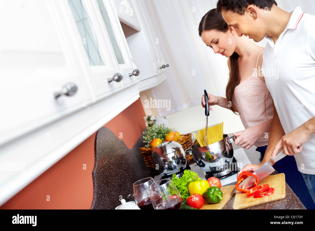 Portrait of amorous couple cooking spaghetti in the kitchen Stock Photo ...