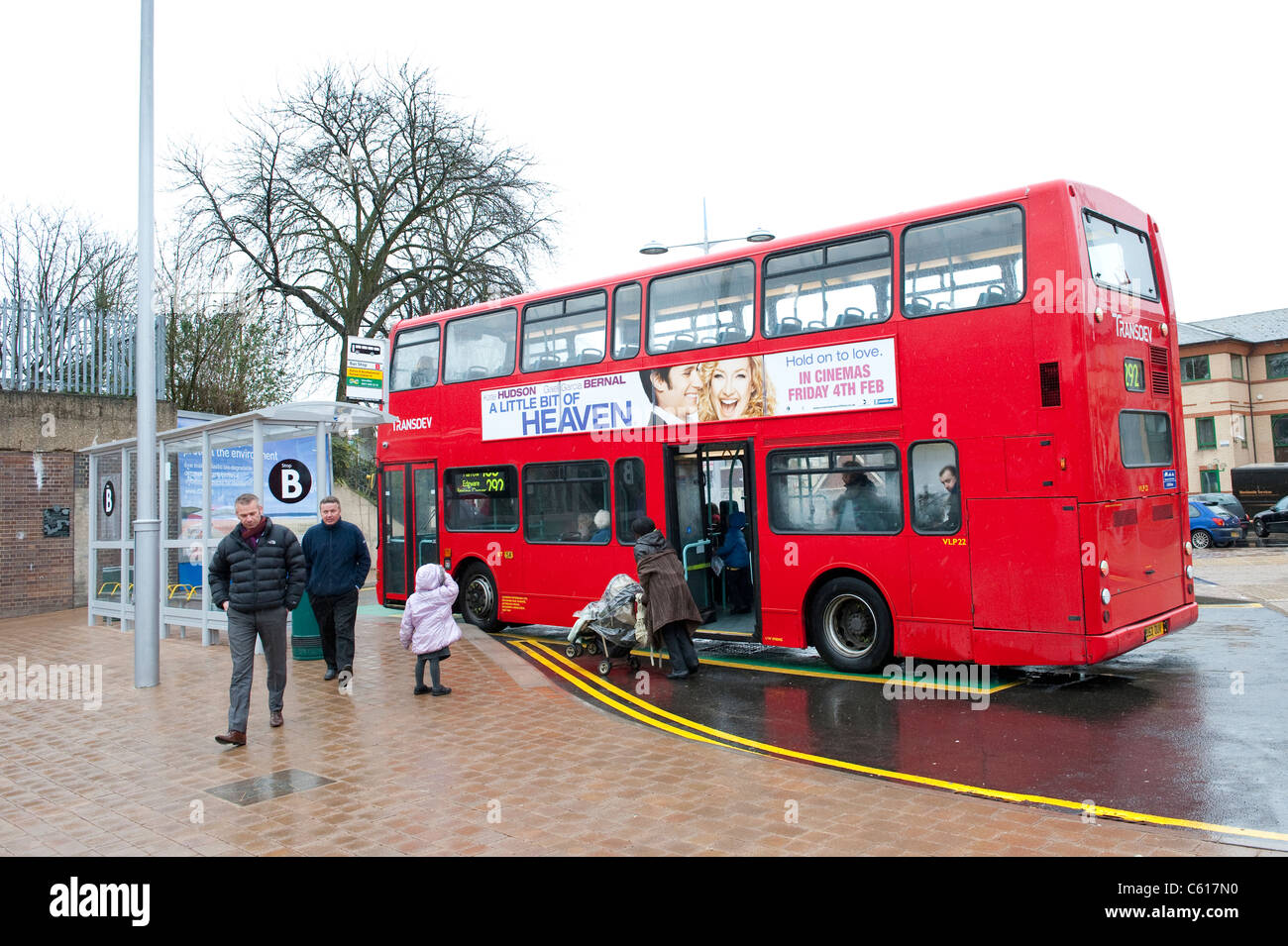 Passengers boarding a red double decker bus in Transdev livery waiting ...
