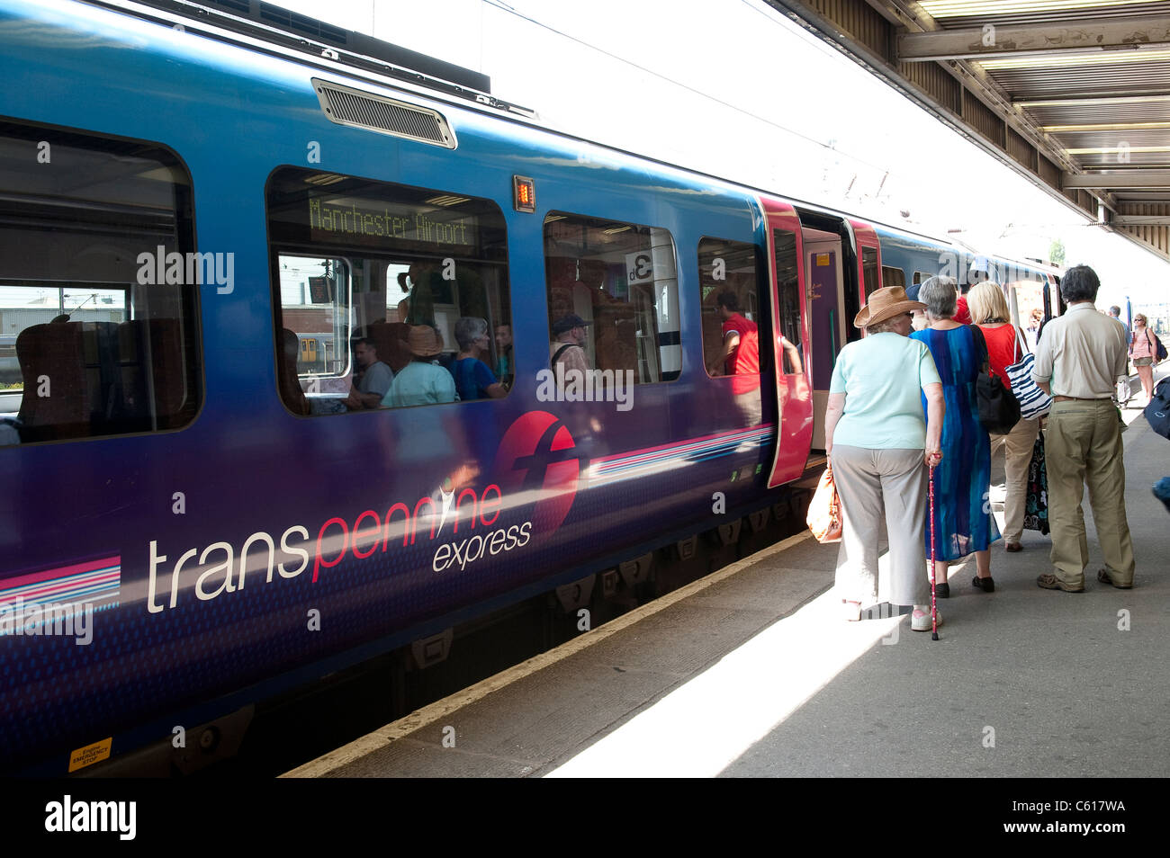 Passengers waiting to board a First Transpennine train at a railway ...