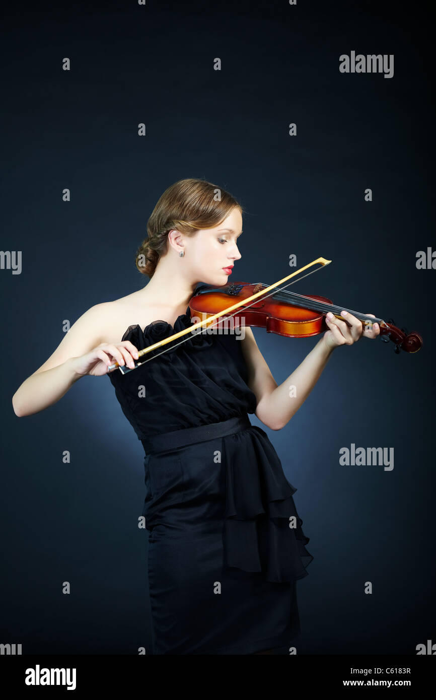 Portrait of a young female playing the violin Stock Photo - Alamy