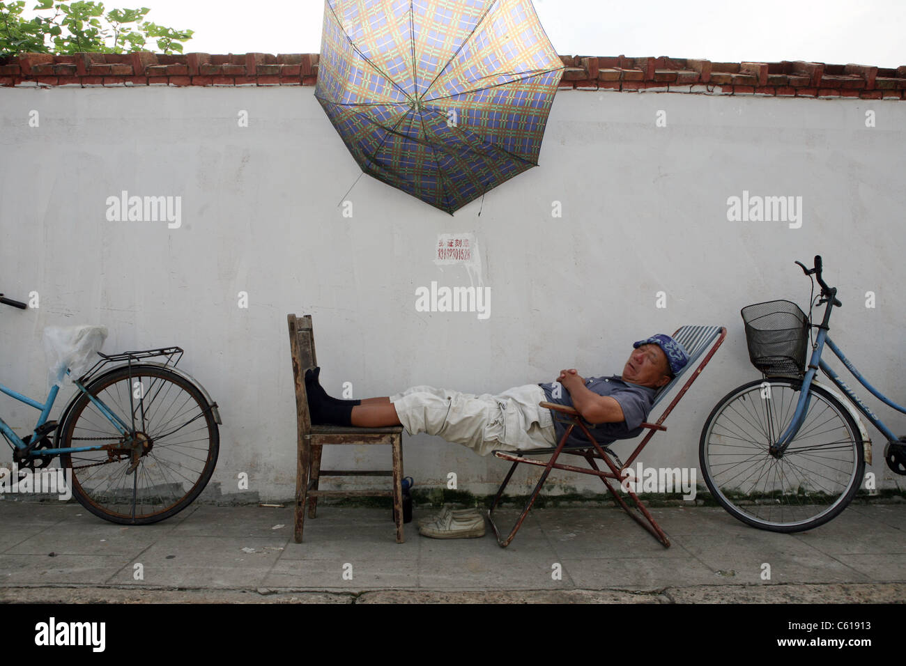 Old man sleeping on chair hi-res stock photography and images - Alamy