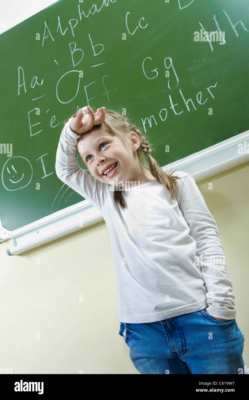 Portrait of smart schoolchild by the blackboard laughing Stock Photo ...