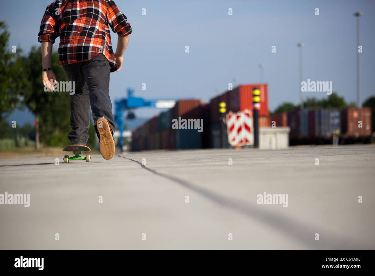 Skateboarder pushing into the distance Stock Photo - Alamy