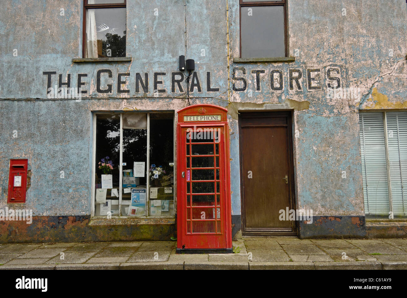 Red telephone box outside the closed general store in the Welsh village ...