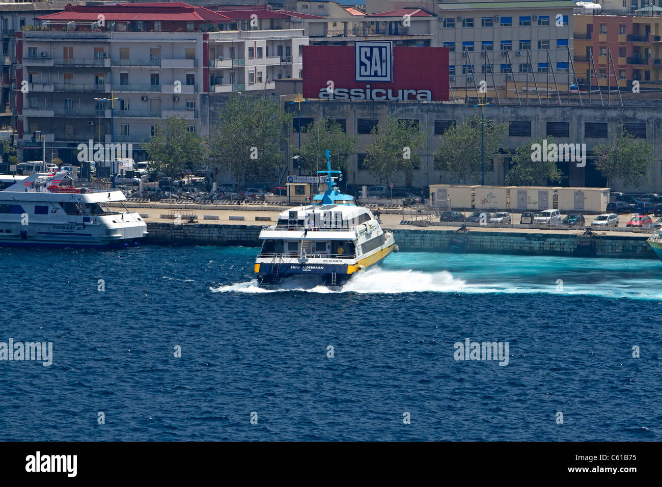 Ferry boat ship cruise along coast of Mediterranean Sea into Messina ...